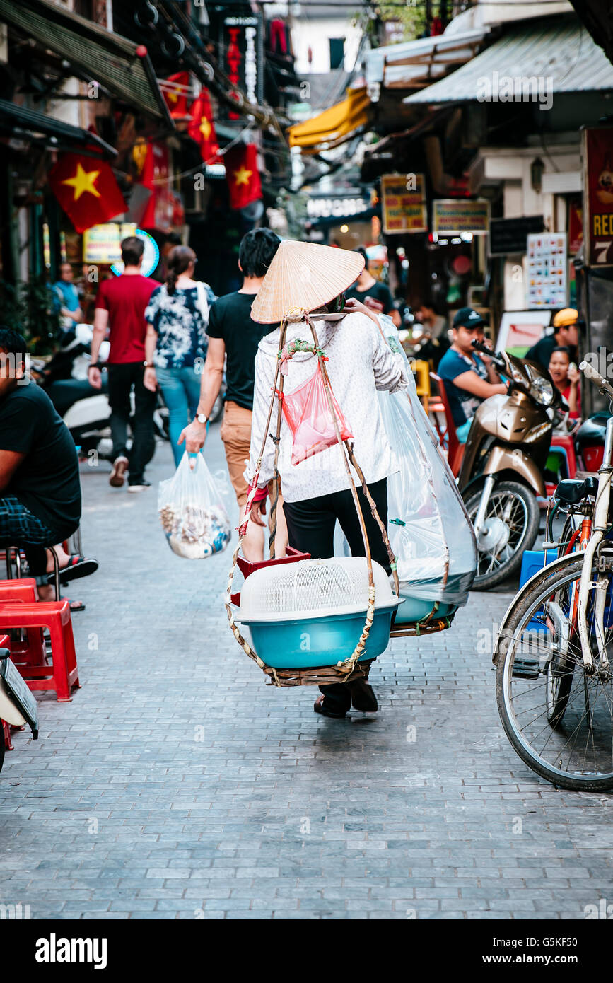 Vendor walking on urban street Stock Photo - Alamy