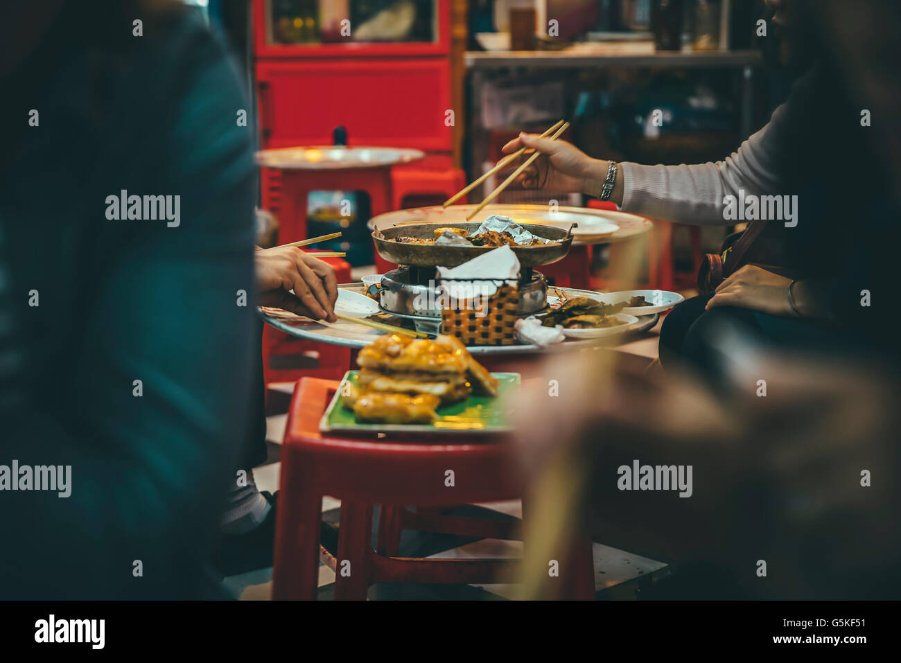 People eating with chopsticks in restaurant Stock Photo - Alamy