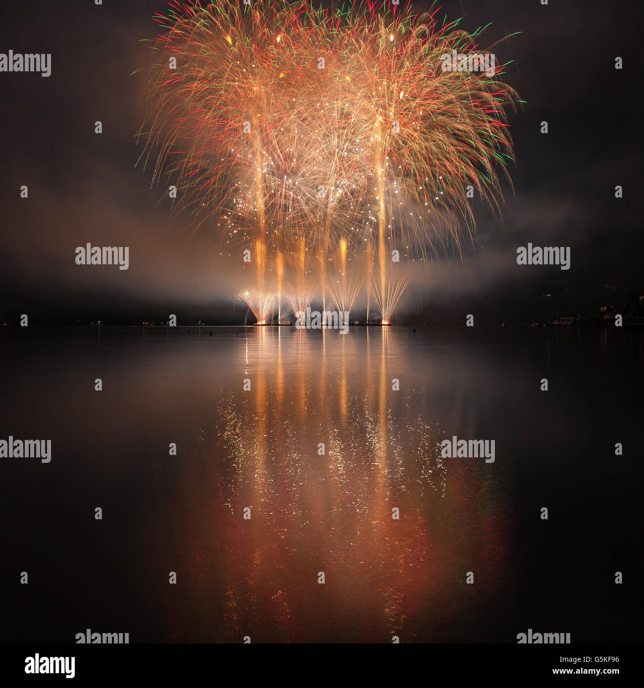 Colorful fireworks with reflection on lake and night sky in background ...