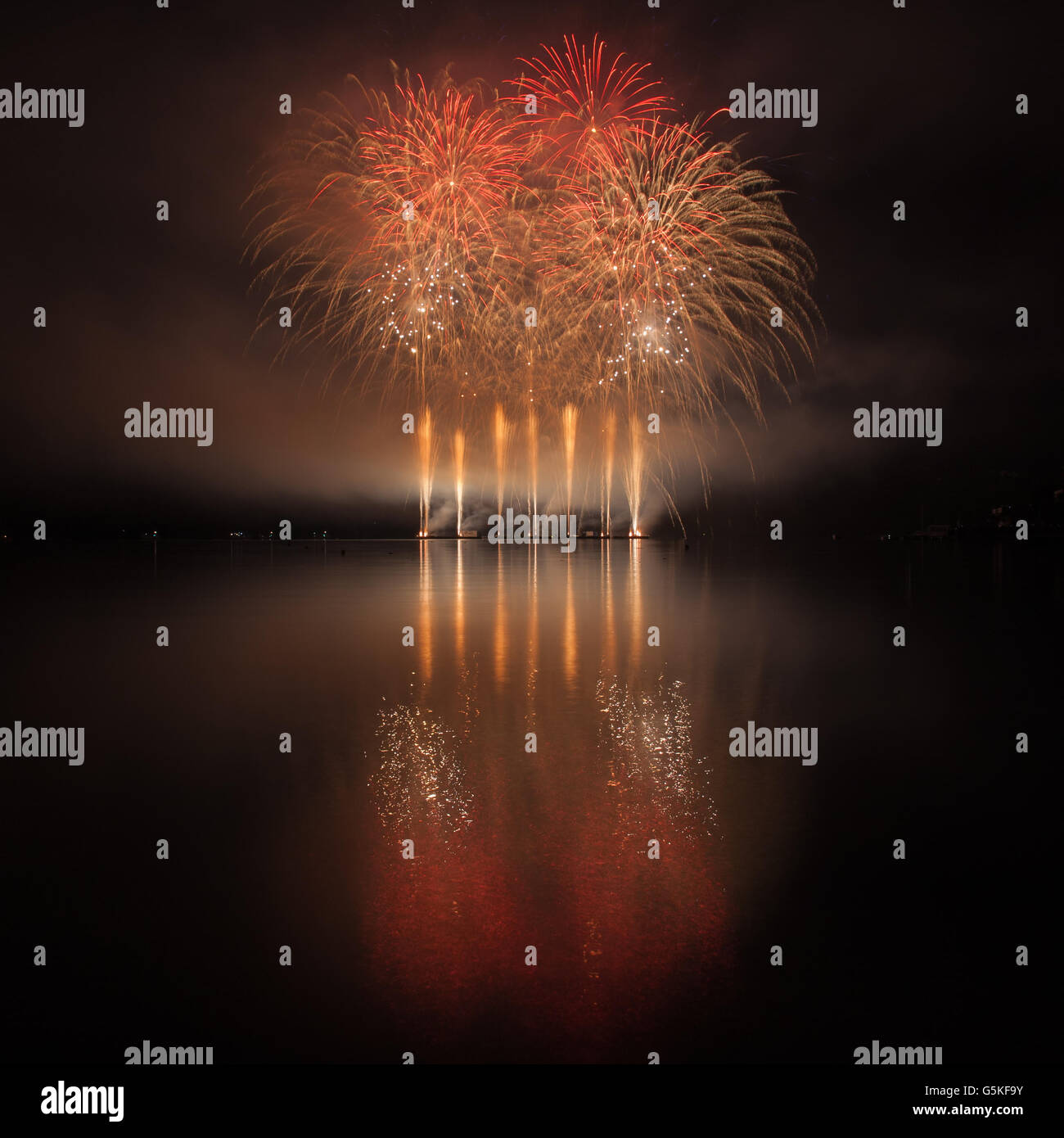 Colorful fireworks with reflection on lake and night sky in background ...