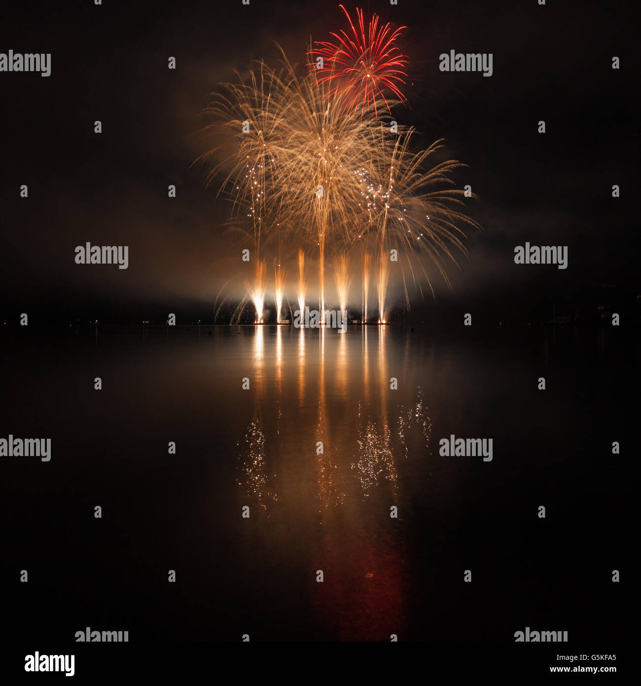 Colorful fireworks with reflection on lake and night sky in background ...
