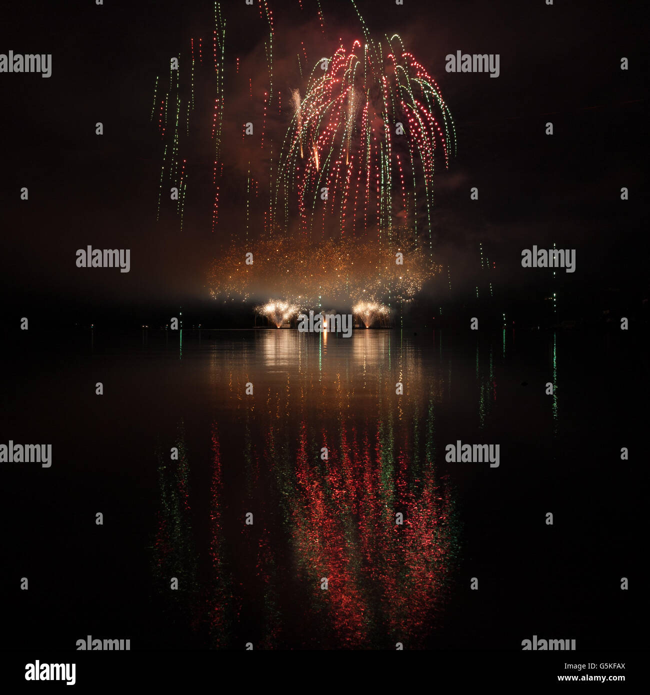 Colorful fireworks with reflection on lake and night sky in background ...