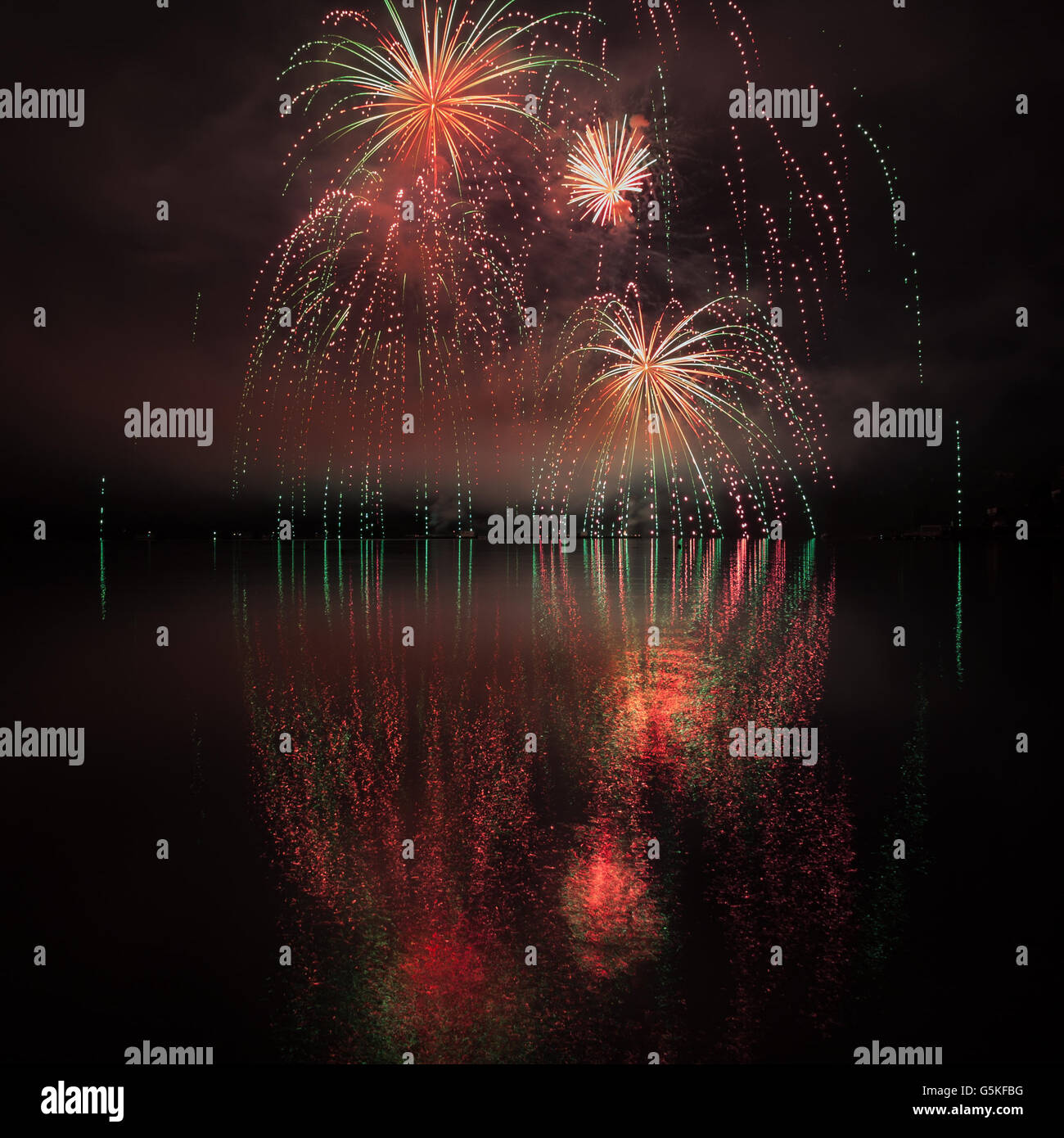 Colorful fireworks with reflection on lake and night sky in background ...