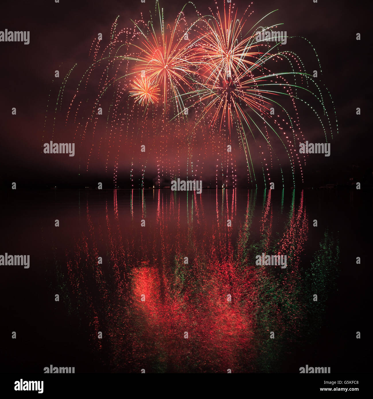 Colorful fireworks with reflection on lake and night sky in background ...