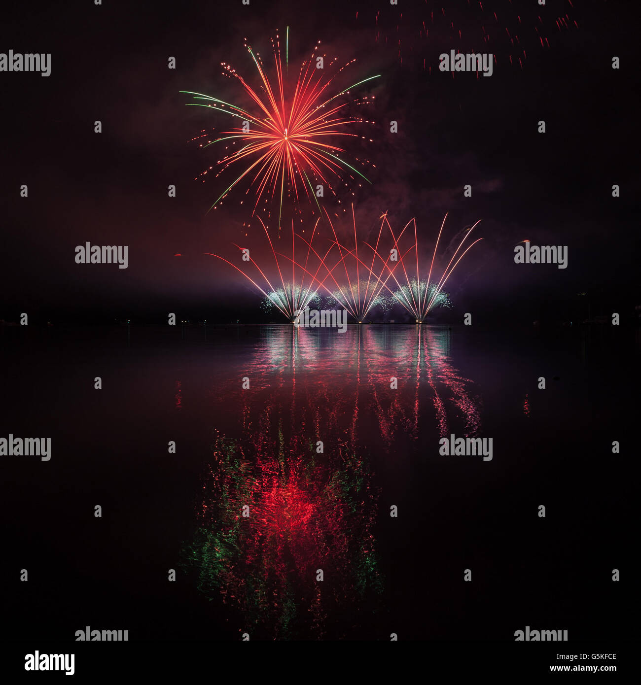 Colorful fireworks with reflection on lake and night sky in background ...