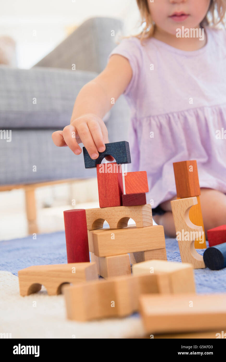 Caucasian girl playing with wooden blocks Stock Photo - Alamy