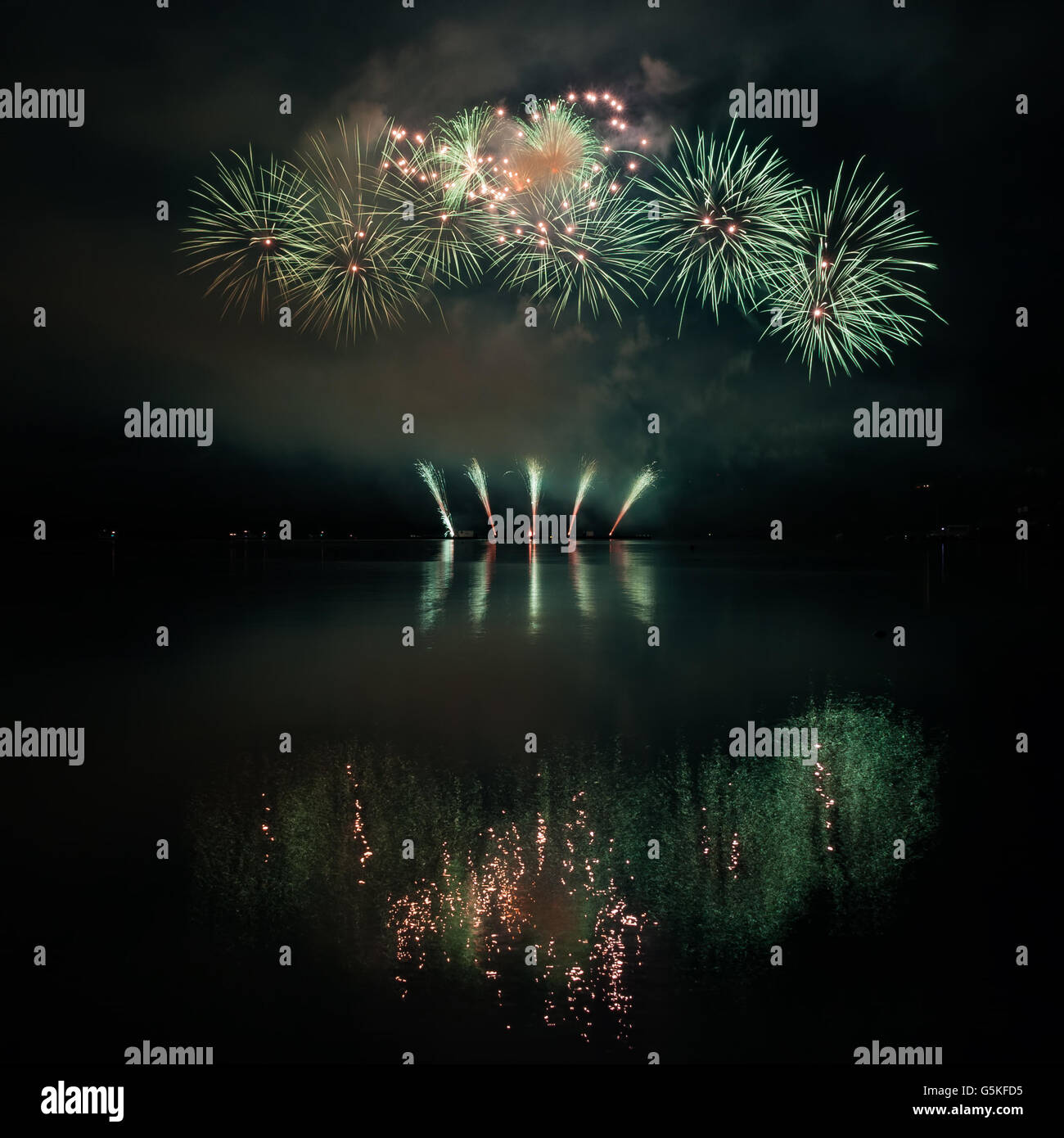 Colorful fireworks with reflection on lake and night sky in background ...