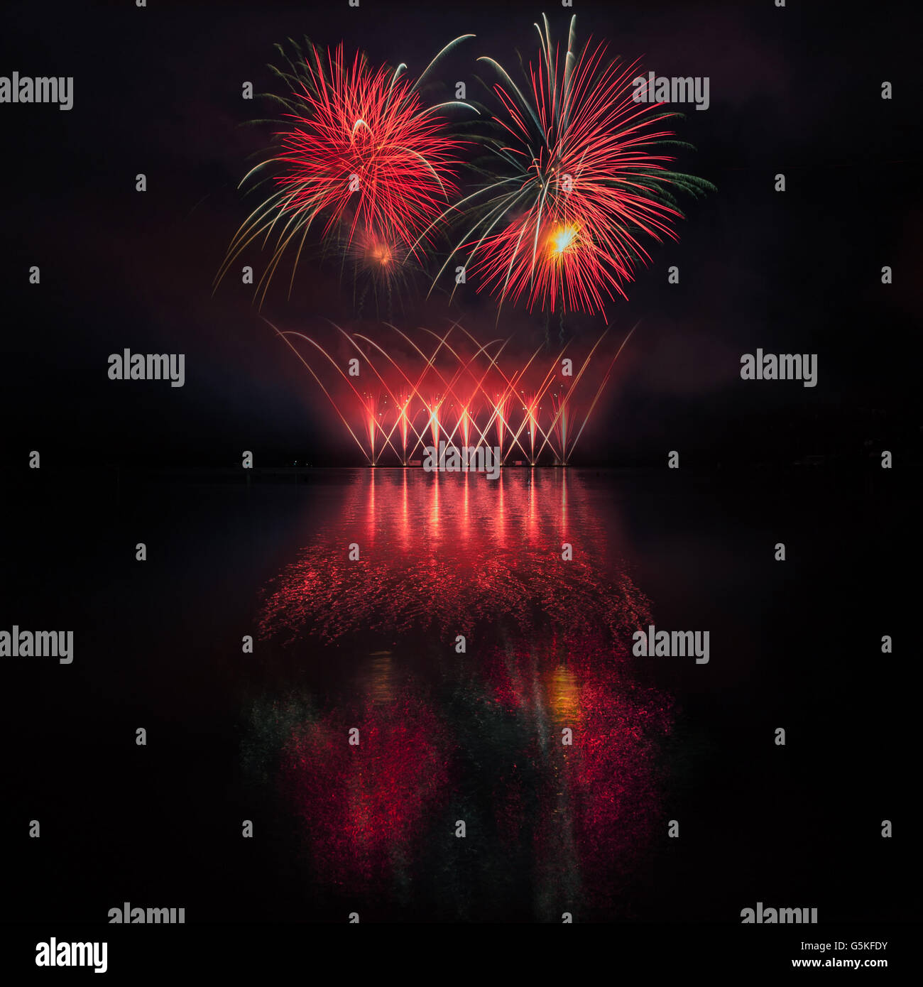Colorful fireworks with reflection on lake and night sky in background ...