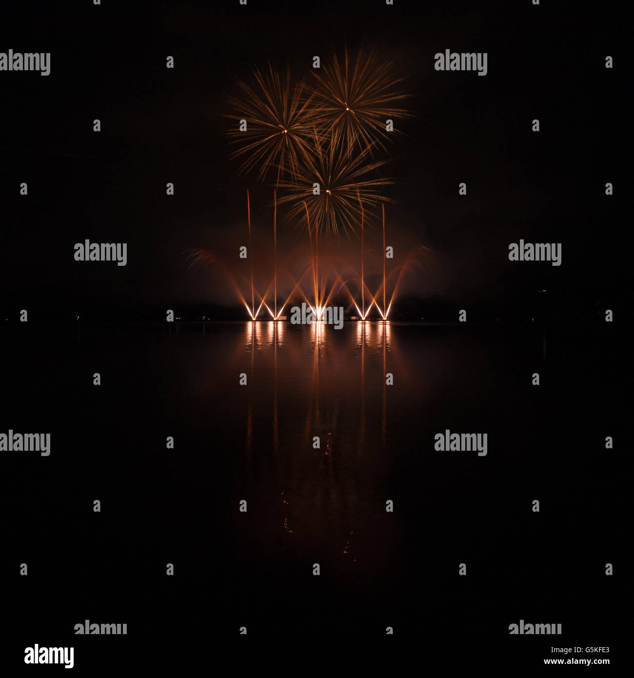 Colorful fireworks with reflection on lake and night sky in background ...