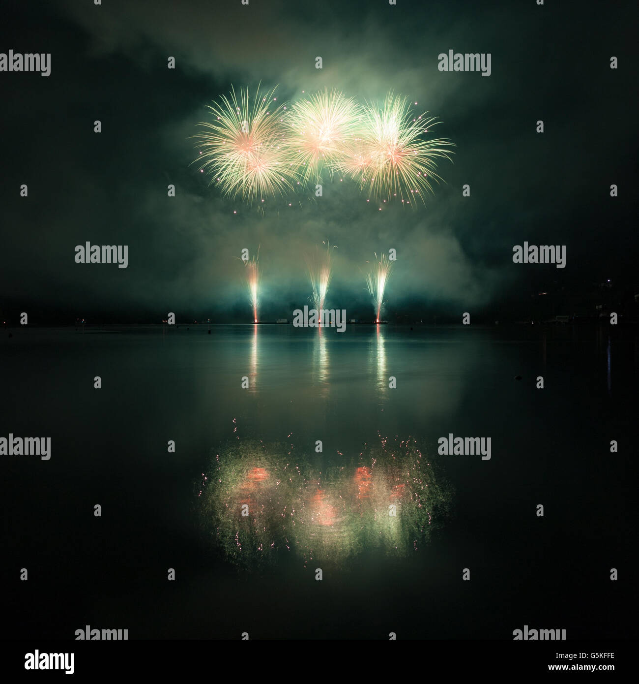 Colorful fireworks with reflection on lake and night sky in background ...