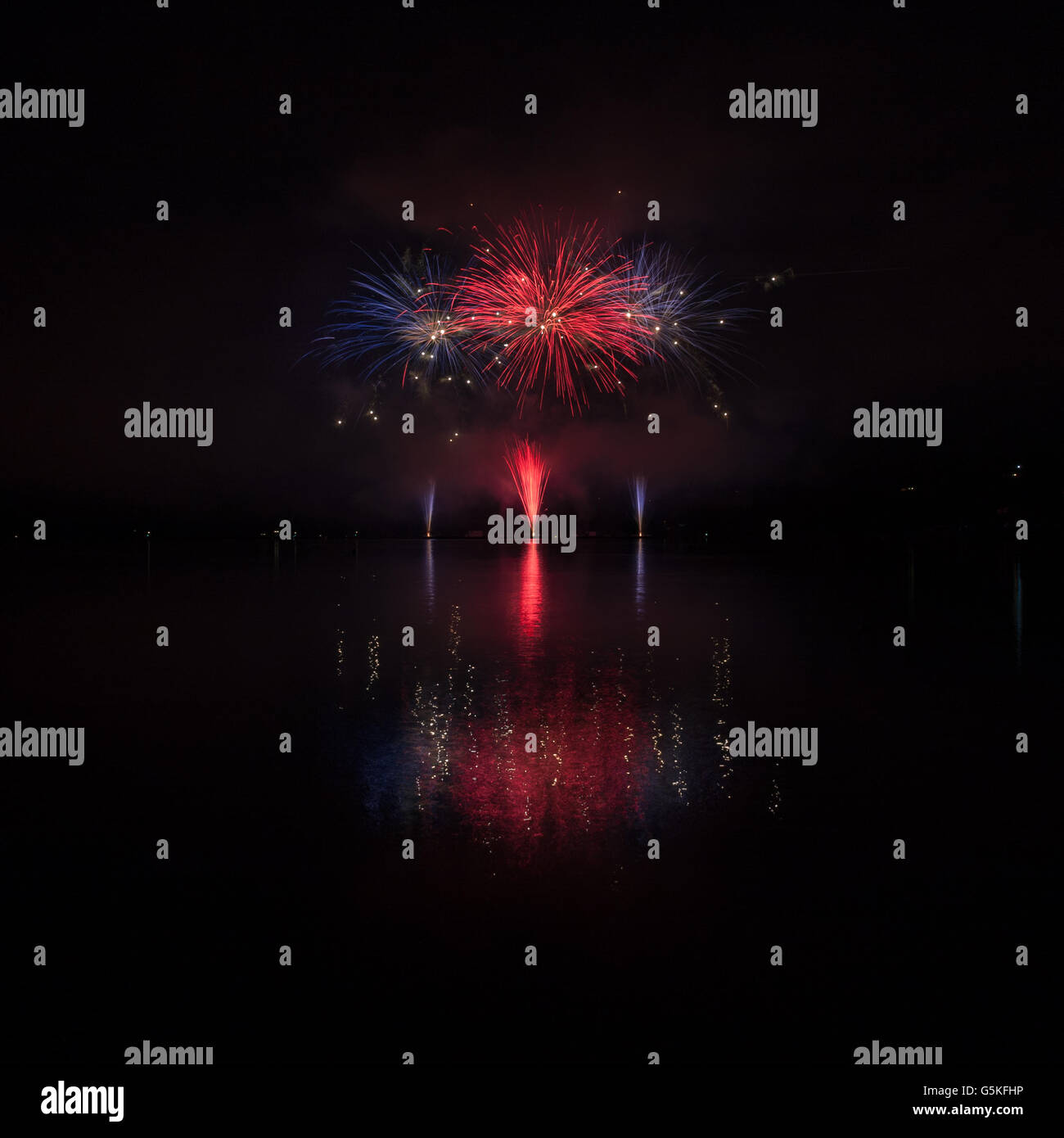 Colorful fireworks with reflection on lake and night sky in background ...