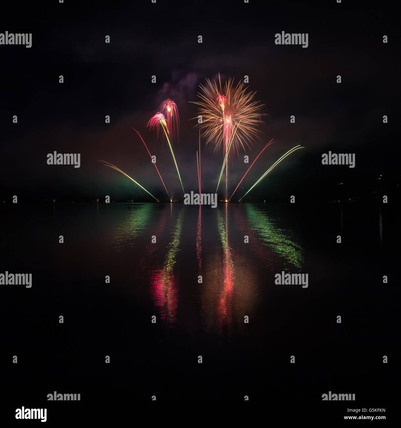 Colorful fireworks with reflection on lake and night sky in background ...