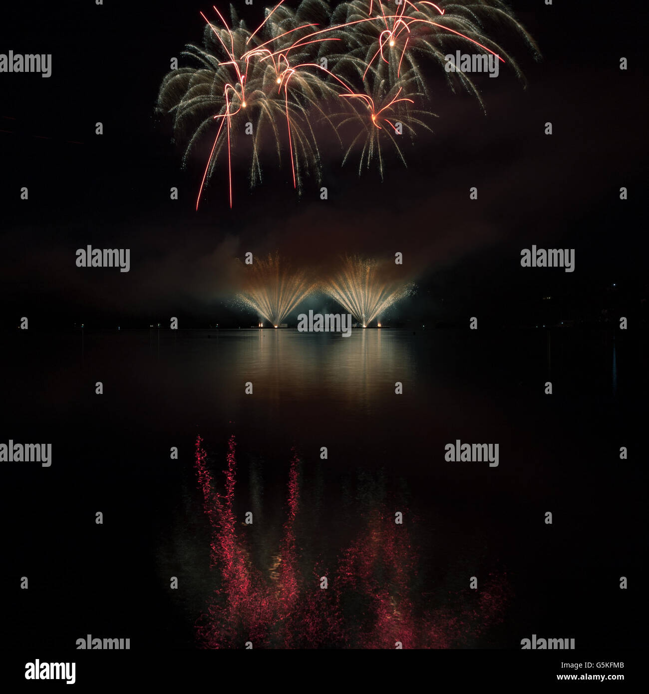 Colorful fireworks with reflection on lake and night sky in background ...