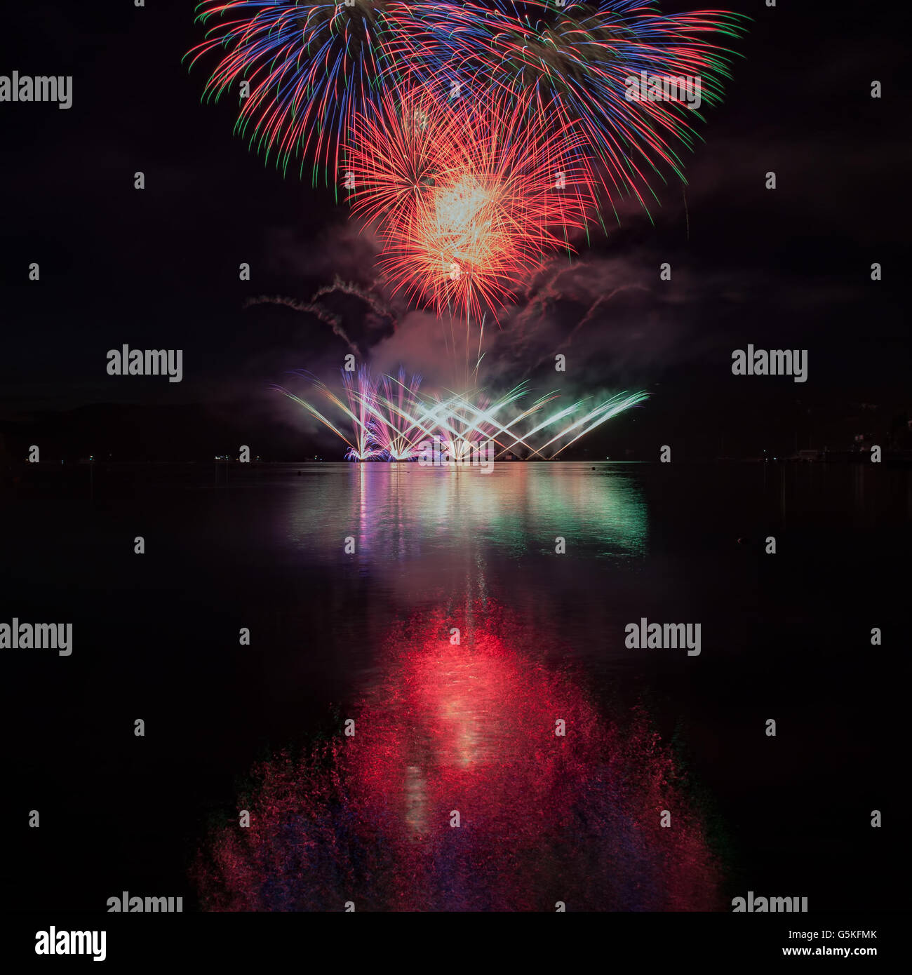 Colorful fireworks with reflection on lake and night sky in background ...