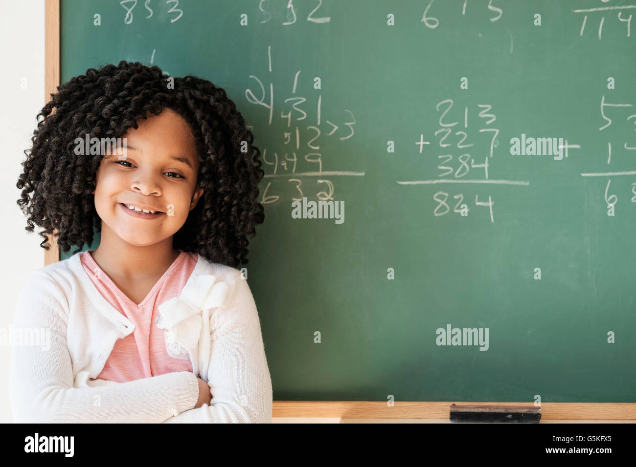 African American student smiling near chalkboard in classroom Stock ...