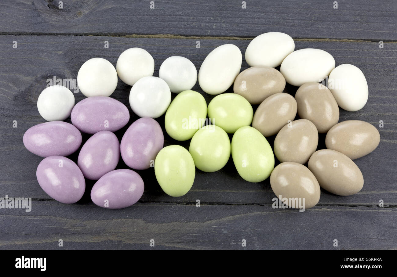 Colored sugared almonds on blue gray wooden background Stock Photo - Alamy