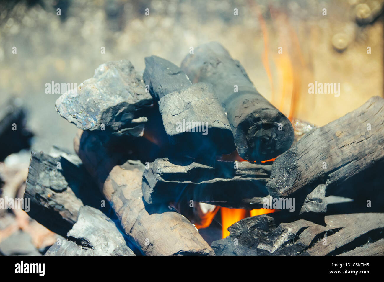 Photograph of some wood charcoal pieces and fire flames Stock Photo - Alamy