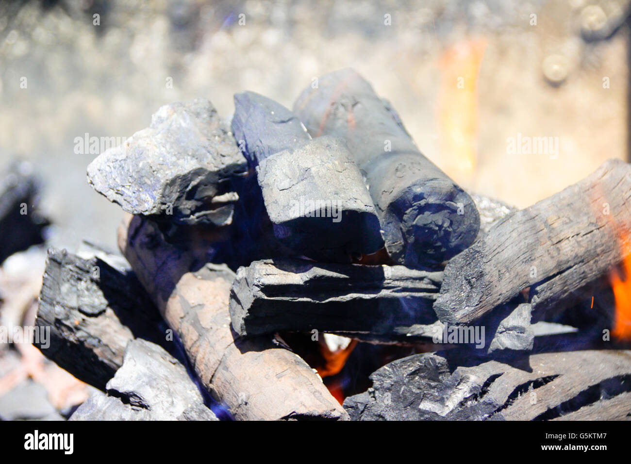 Photograph of some wood charcoal pieces and fire flames Stock Photo - Alamy