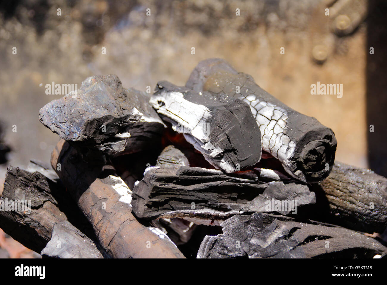 Photograph of some wood charcoal pieces and fire flames Stock Photo - Alamy