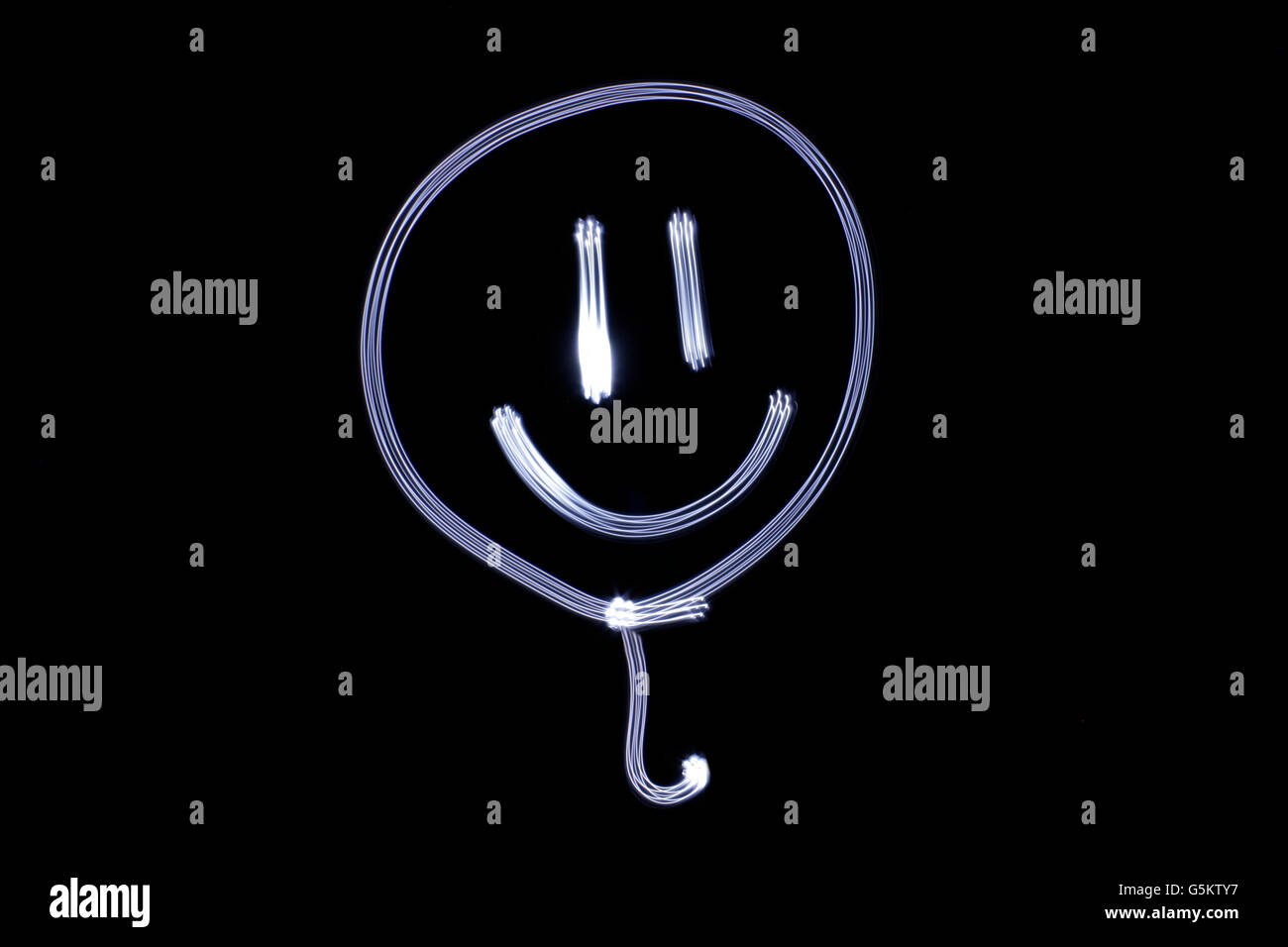 Photograph of a balloon with happy face and smile light drawing with a ...