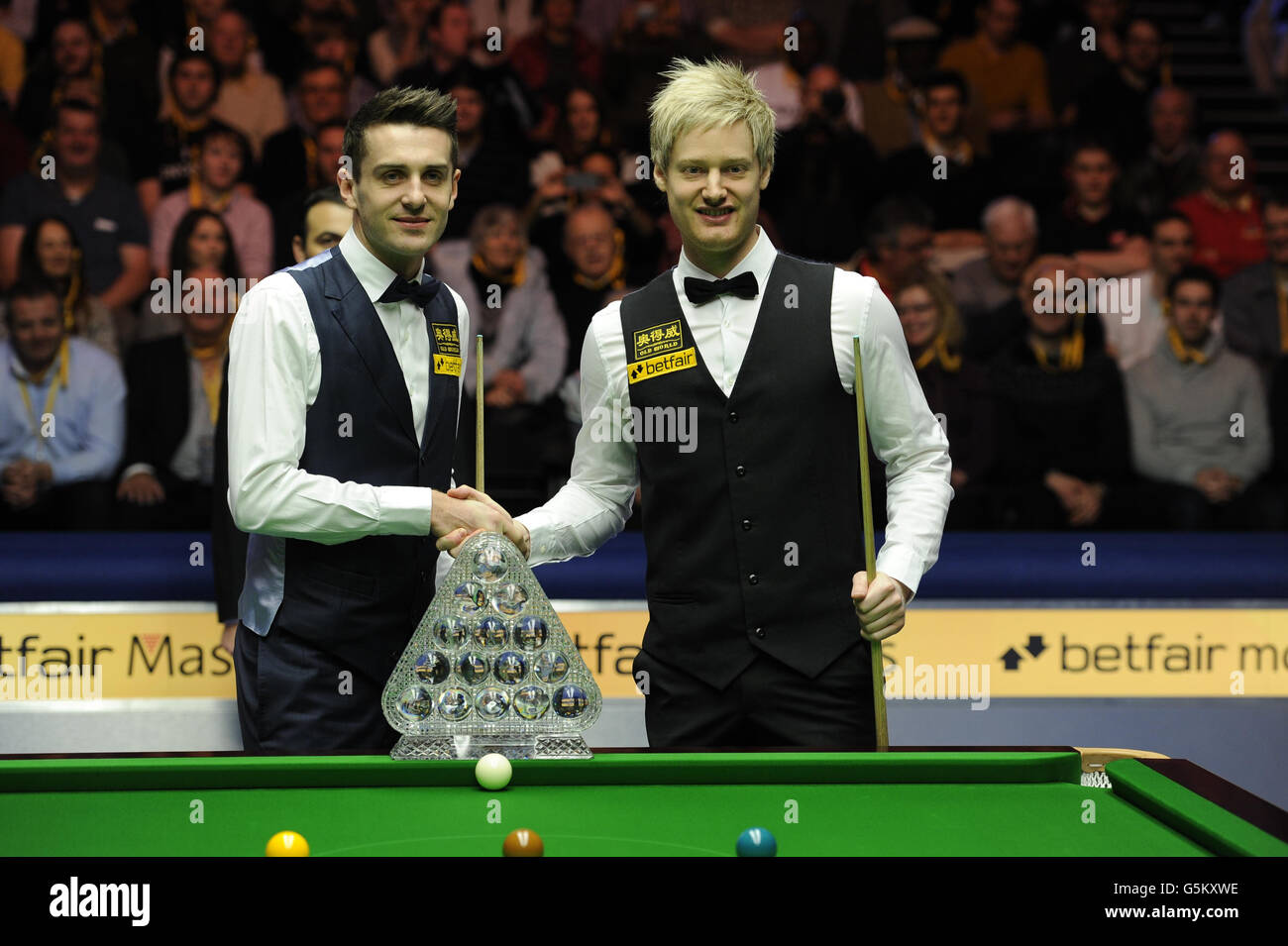 Mark Selby (left) and Neil Robertson shake hands over the trophy before ...