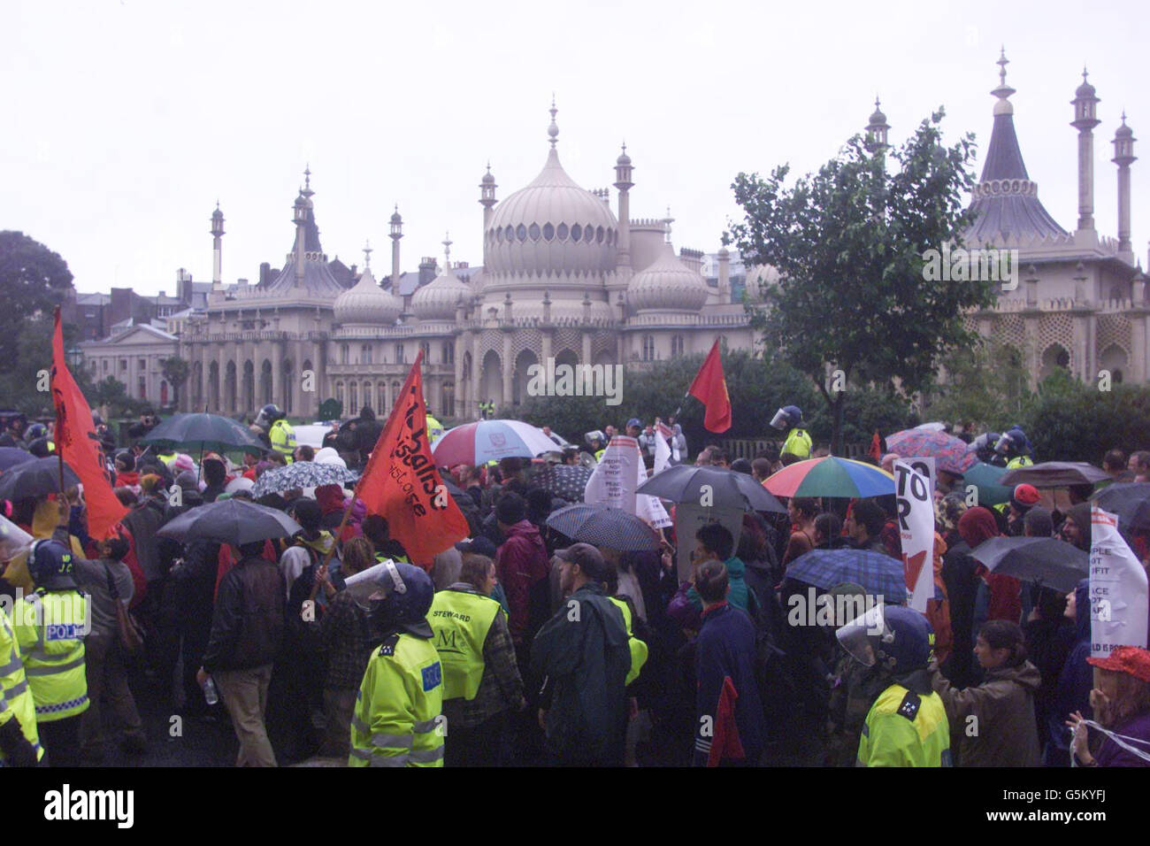 Demonstrators pass the Royal Pavilion during a mass protest as the ...
