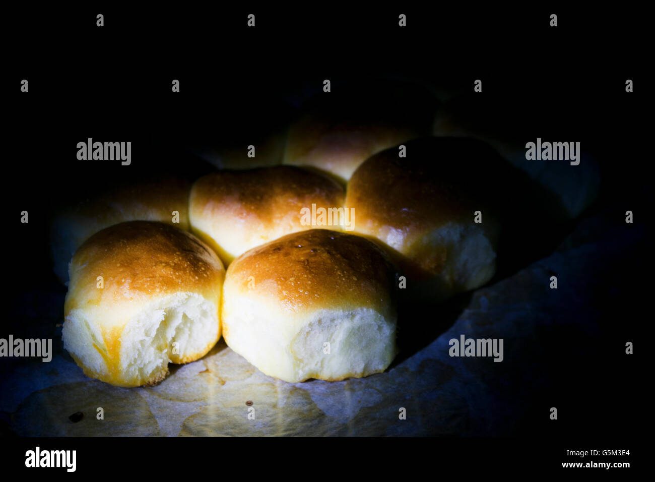 bread rolls at the butter in twilight lit by a grazing light Stock ...