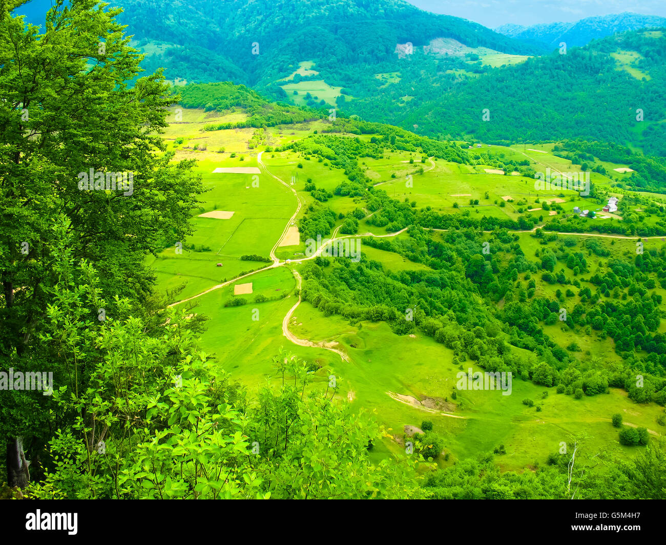 top view of green mountainous valley with the village Stock Photo - Alamy