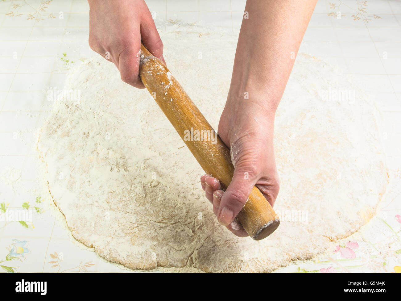 Making dough by female hands on white table background Stock Photo - Alamy