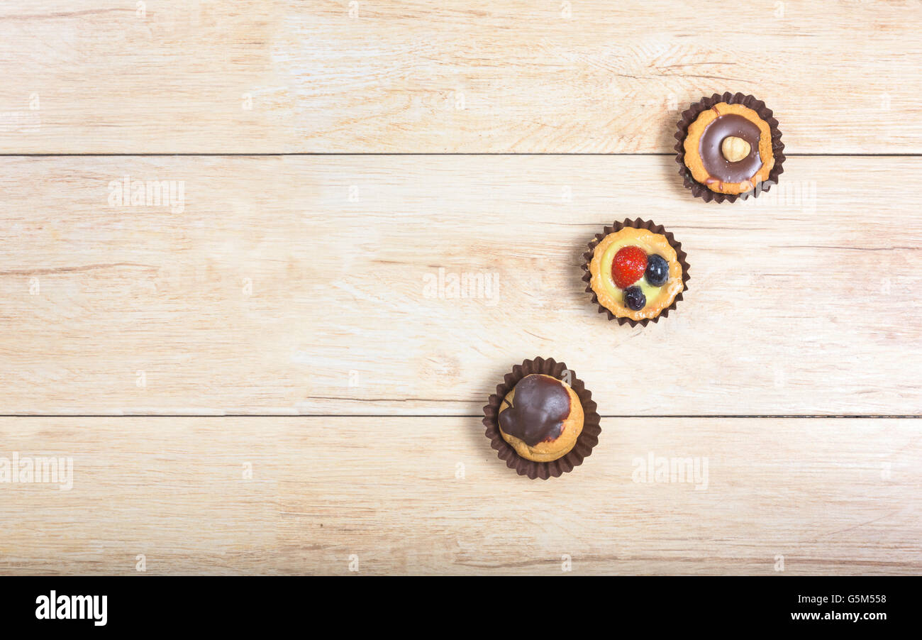 Pictured pastries on light wood background,above view with copy space ...