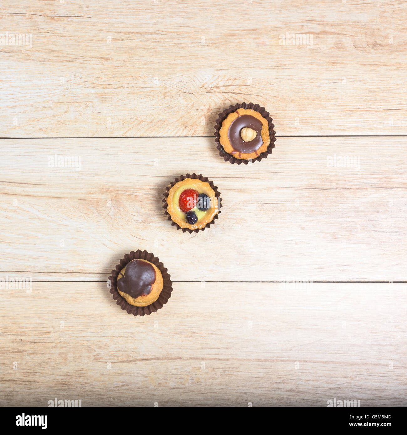 Pictured pastries on light wood background,above view,square photo ...