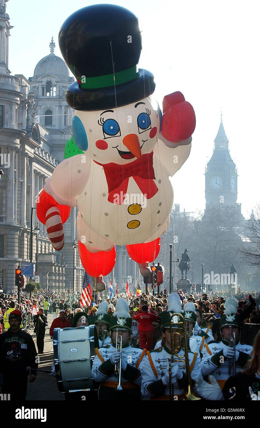Twinkle the snowman floats atop marching bands as they progress up ...