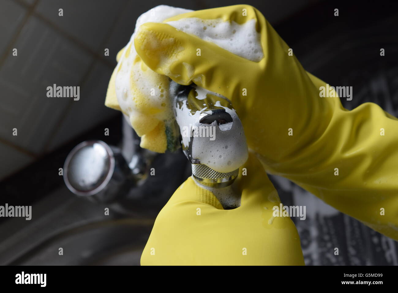 Hands cleaning the tap with gloves Stock Photo - Alamy