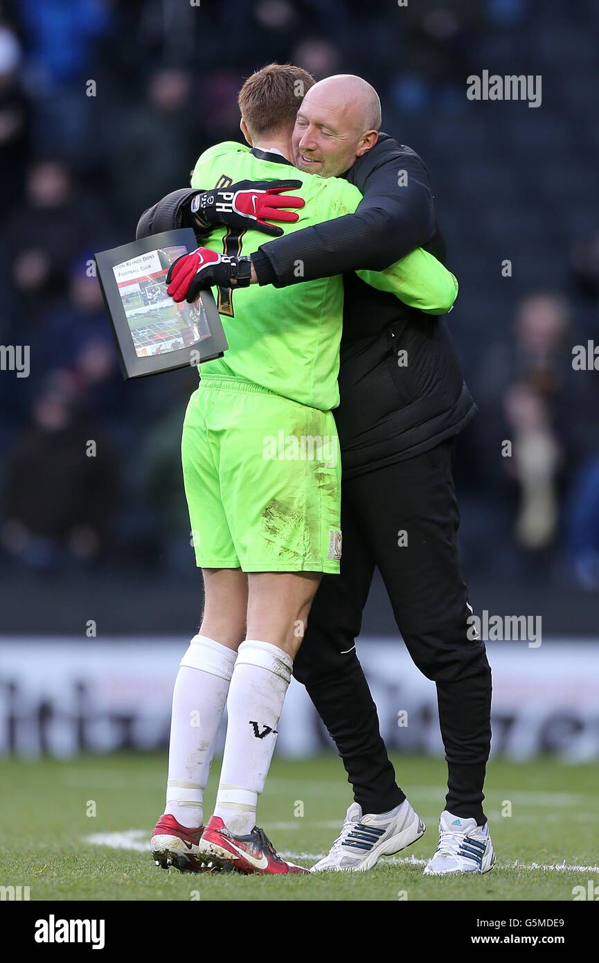Milton Keynes Dons goalkeeper David Martin (left) embraces goalkeeping ...