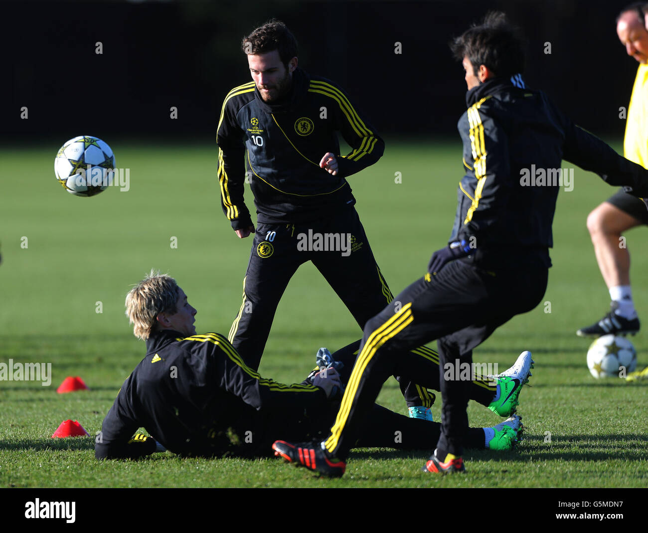 Chelsea's Juan Mata chips the ball as Fernando Torres slides during a ...