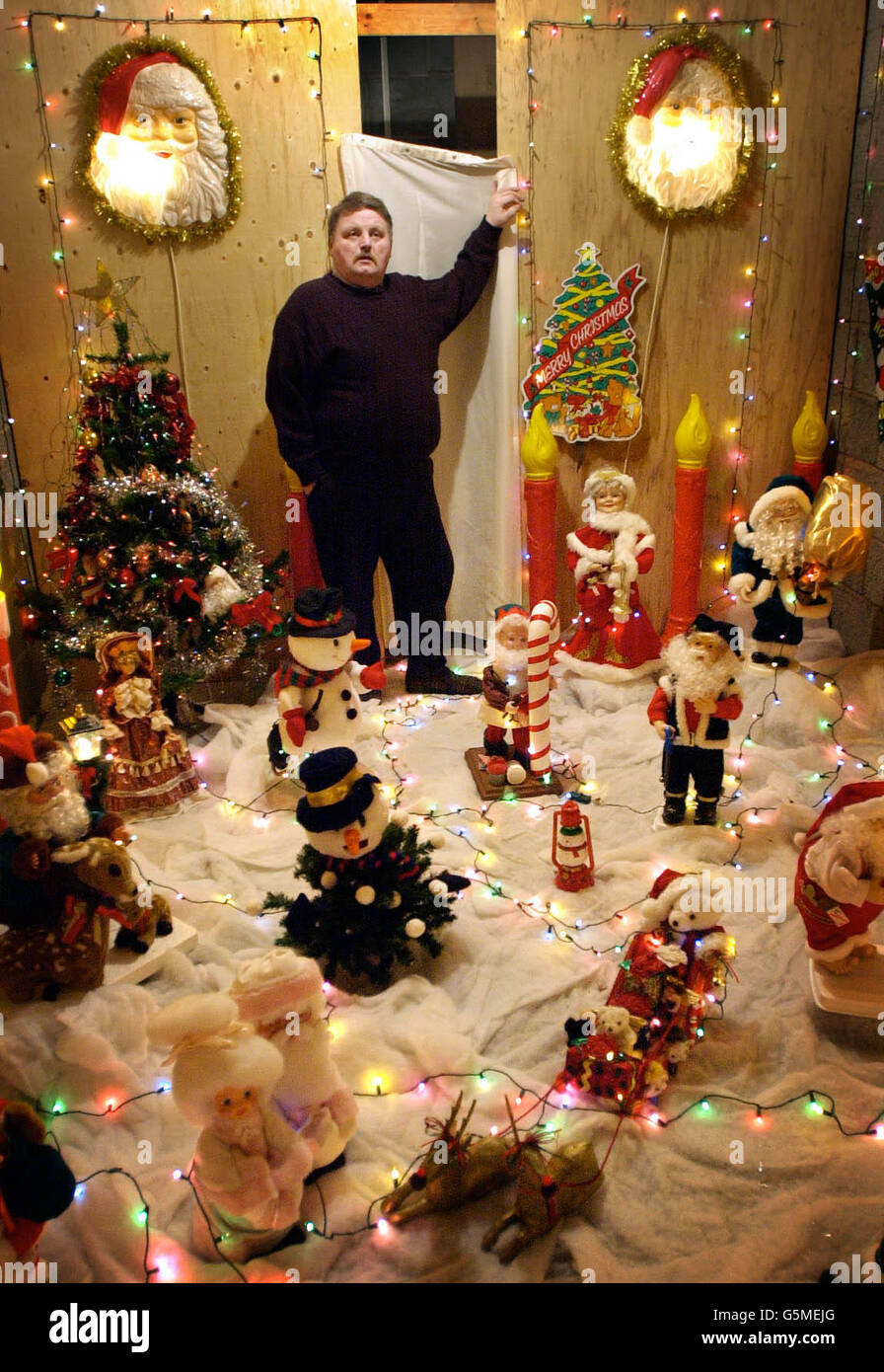 David Rowlands, 51, stands in the festive grotto he has created in his ...