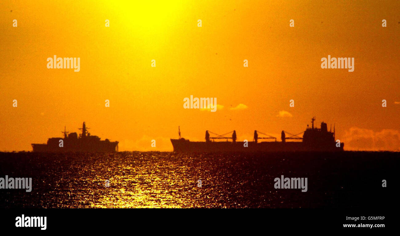 The MV Nisha (right) watched over by the Type 23 frigate HMS Sutherland ...