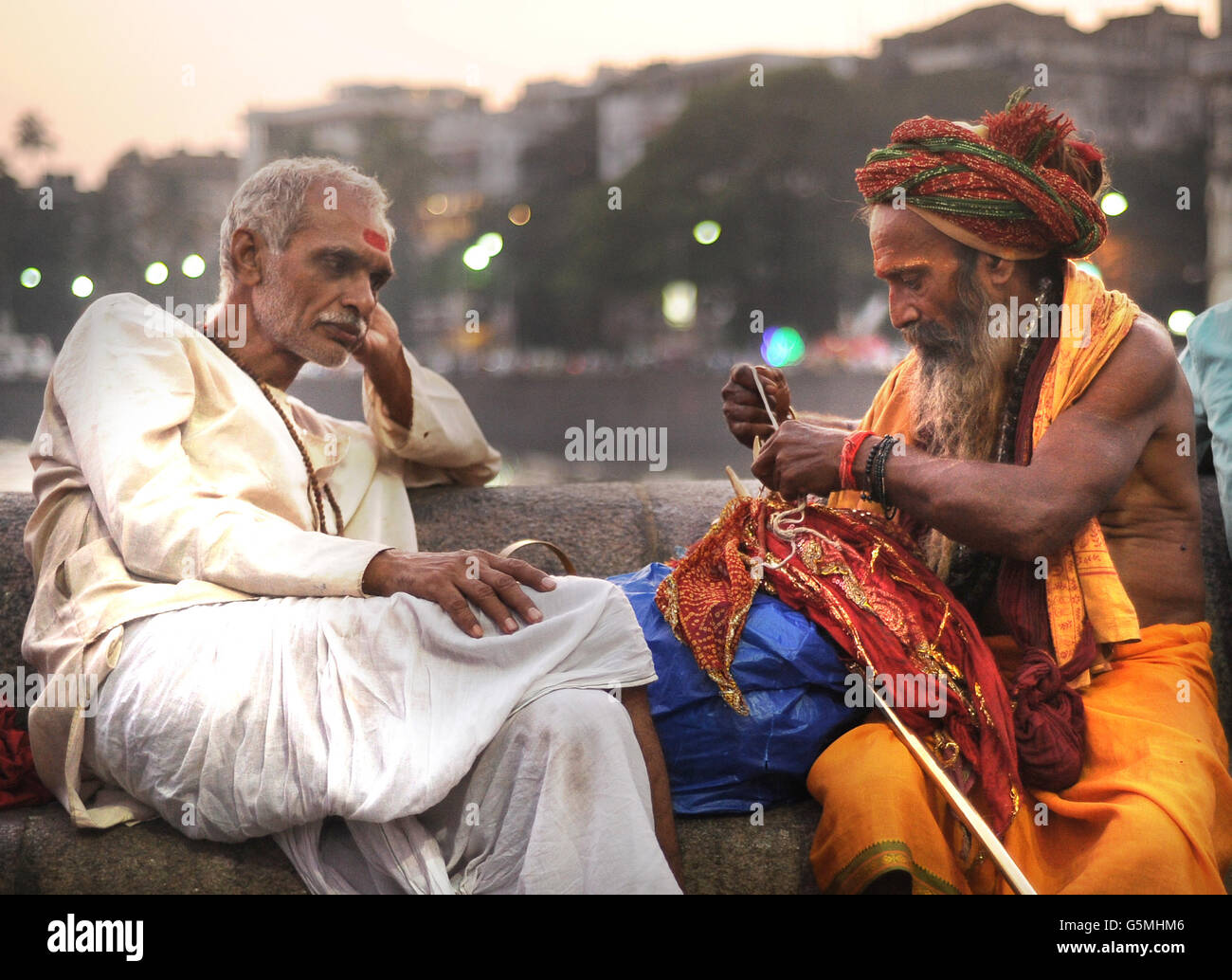 India Travel stock. Two holy men, including a Sadhu (right) sit on the ...