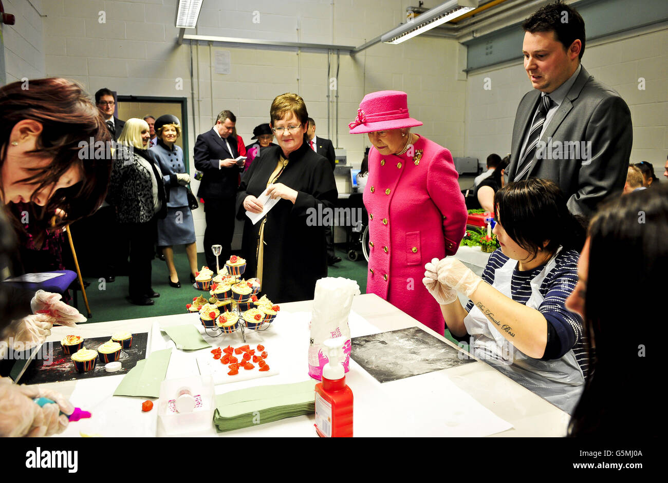 Her Royal Highness Queen Elizabeth II admires cup cakes at Hartcliffe ...