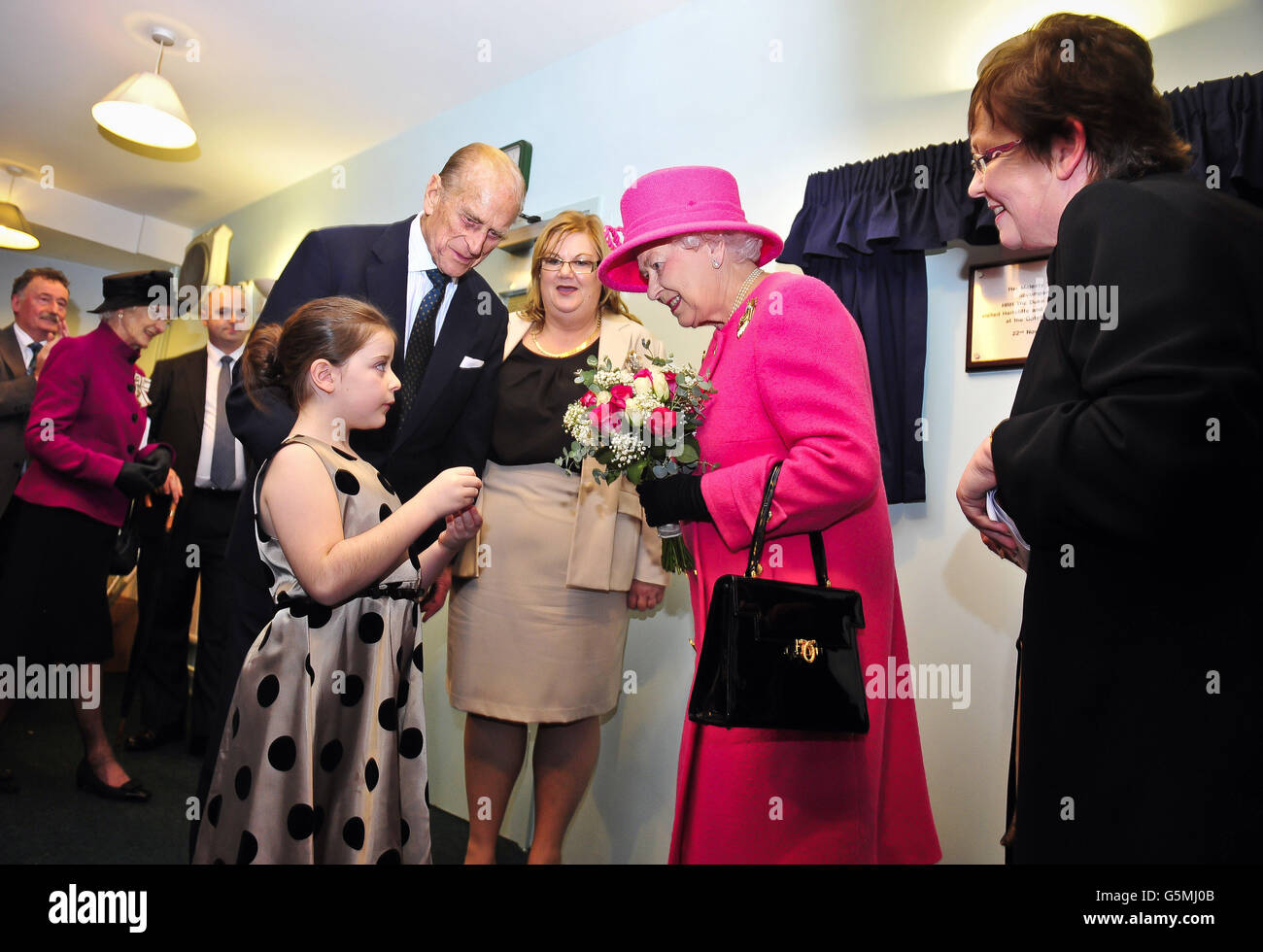 Her Royal Highness Queen Elizabeth II is given some handmade earings ...