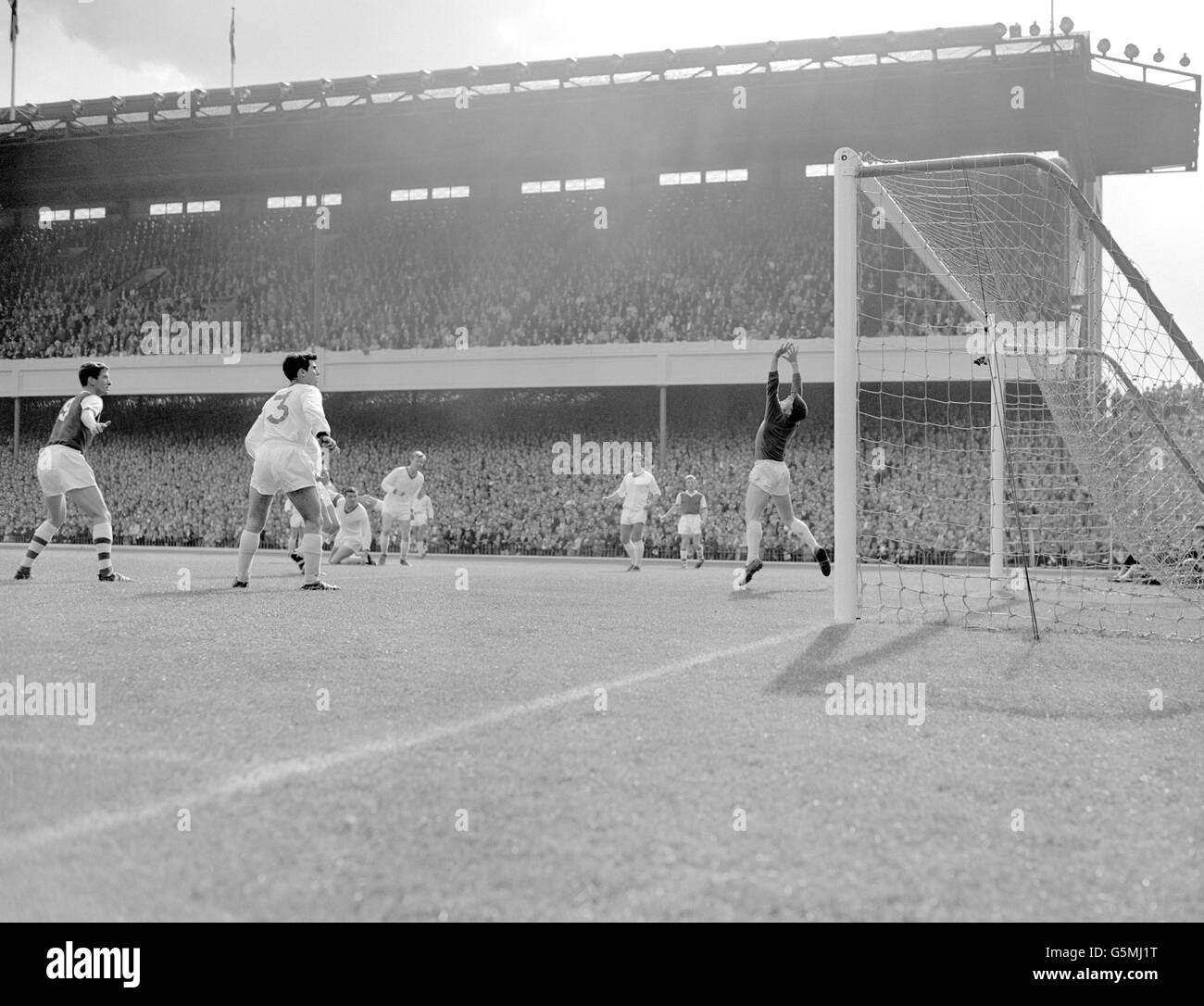 Manchester United goalkeeper John David Gaskell stretches for the ball ...