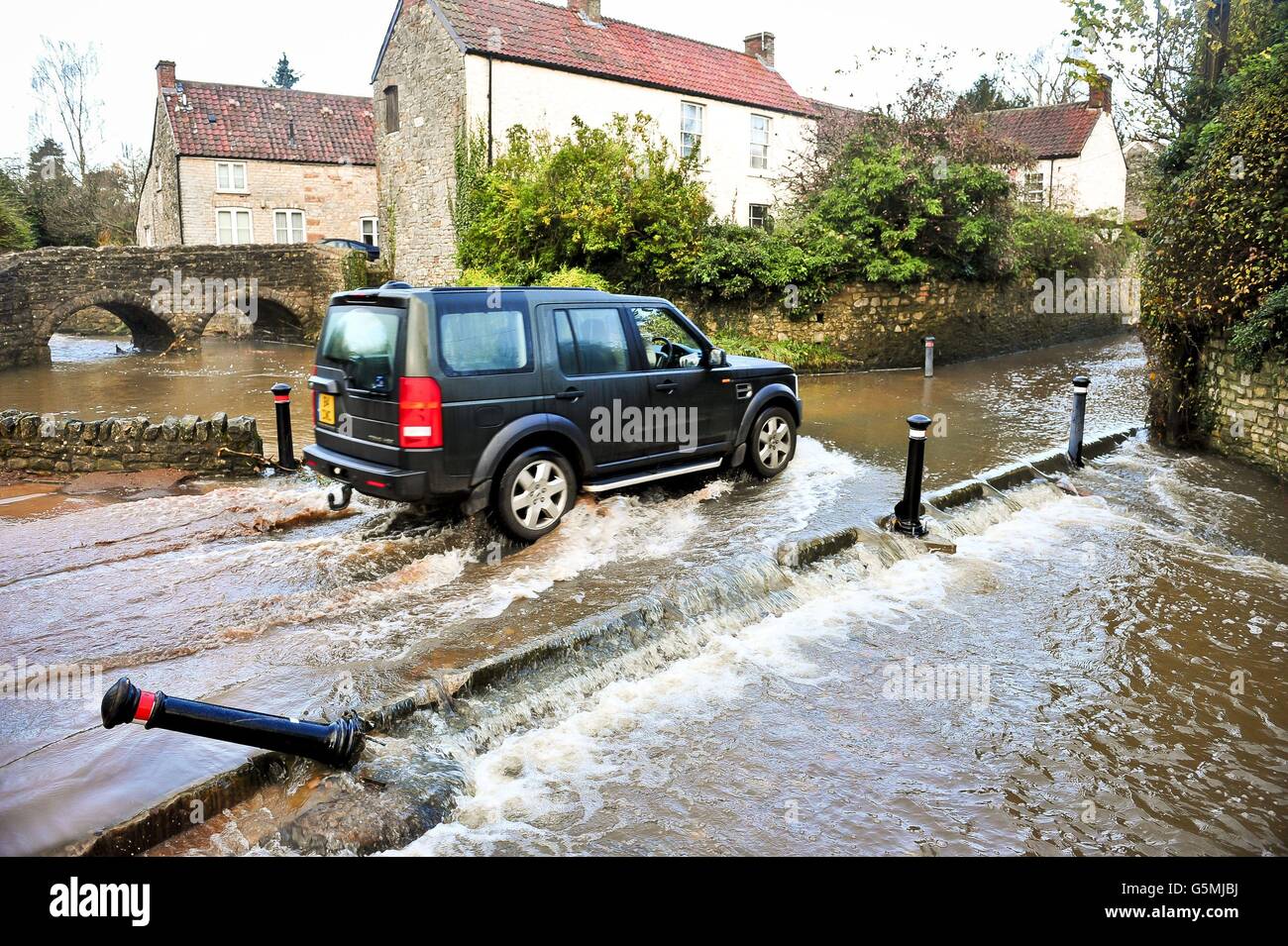 A 4x4 vehicle crosses the ford in the Somerset village of Chew Stoke ...
