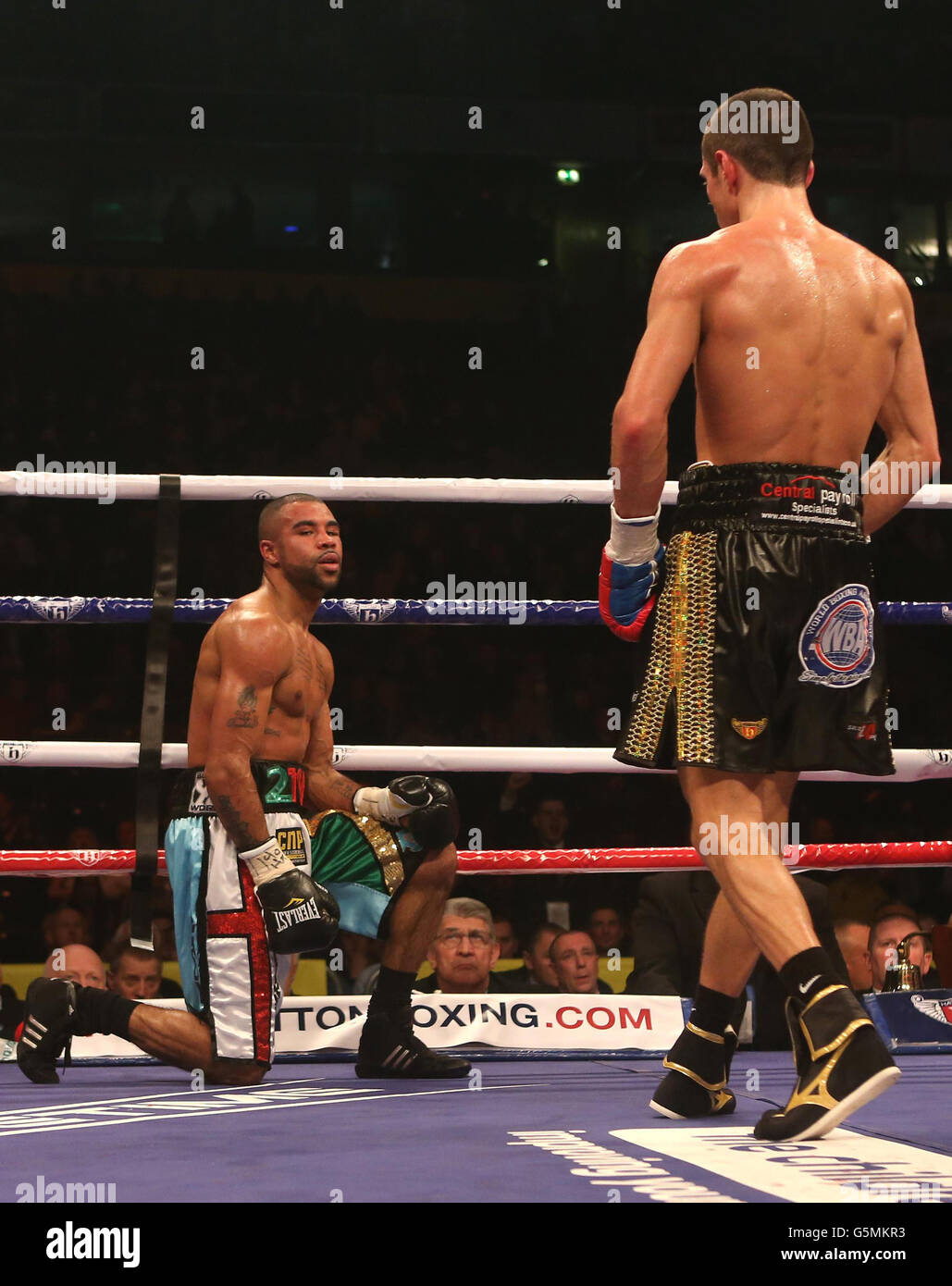 Rendall Munroe sinks to one knee after a body shot from Scott Quigg ...