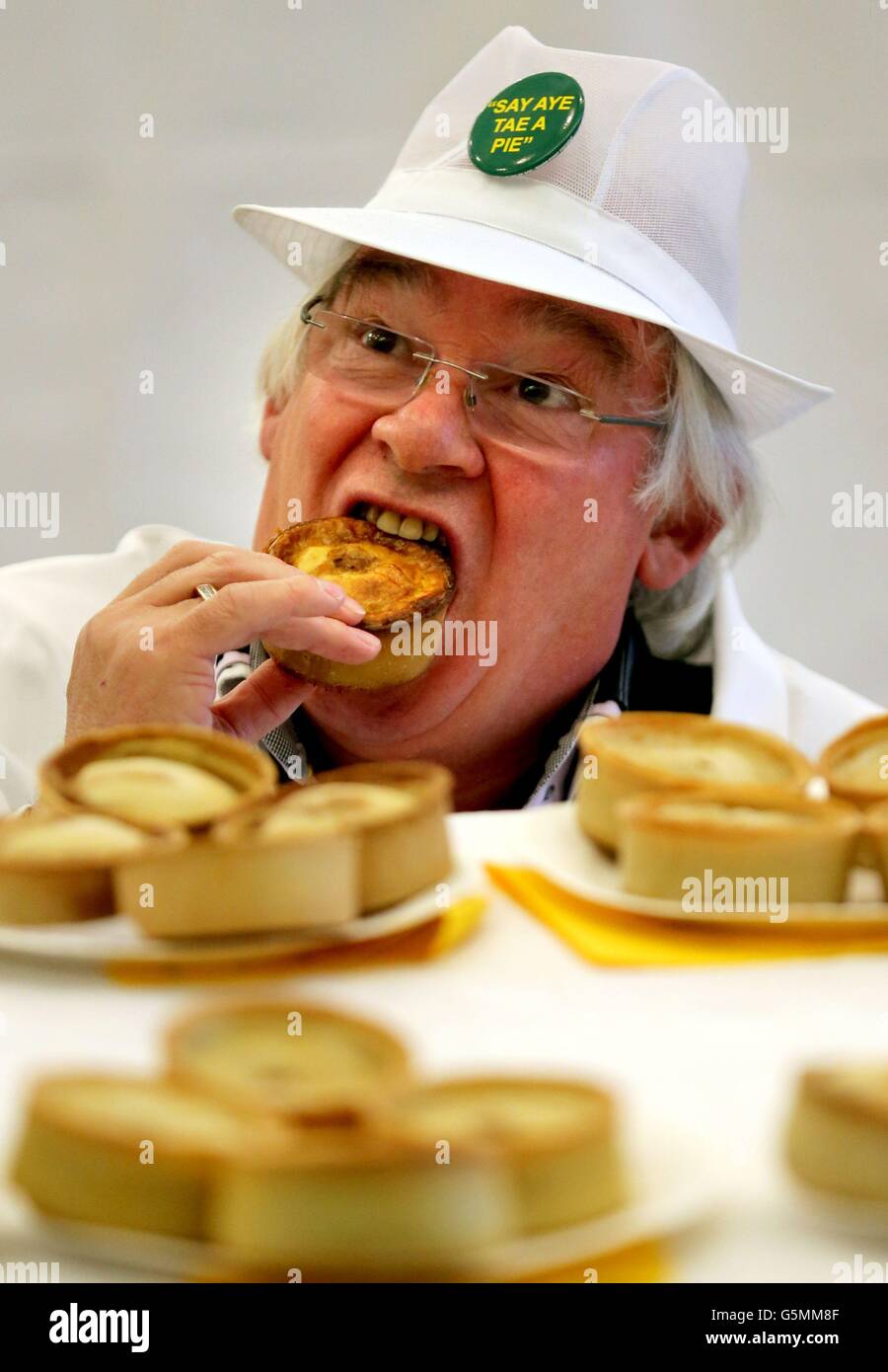 Former Dunfermline manager Jim Leishman tastes pies during judging ...