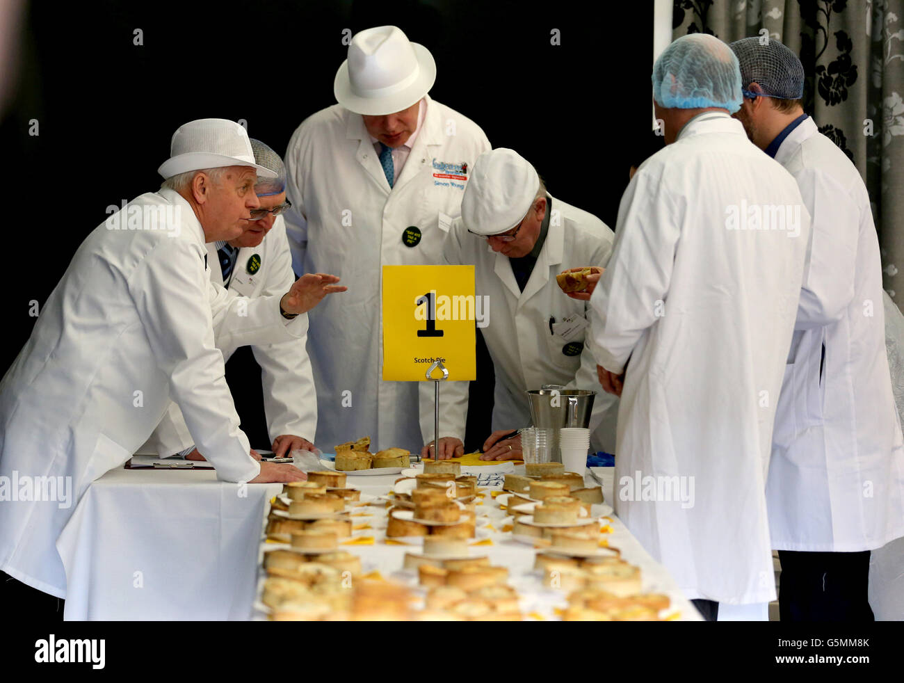 Judge Bill Montgomery (l) speaks to fellow judges during judging of the ...