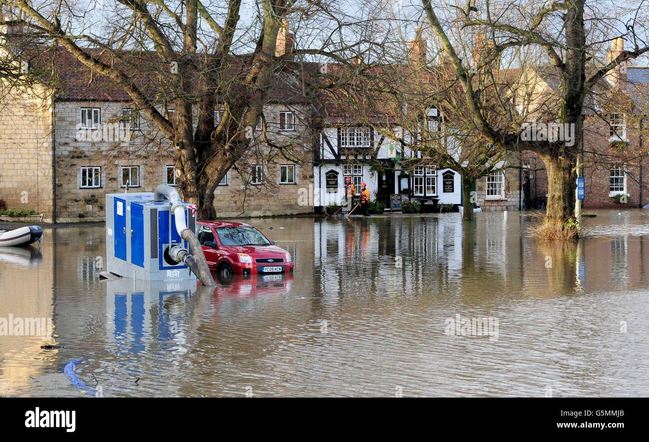 Fire fighters make their way along the flooded main street in Old ...