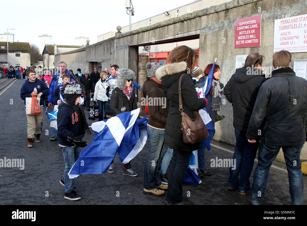 Fans go through the turnstiles at Pittodrie Stadium home of Aberdeen ...