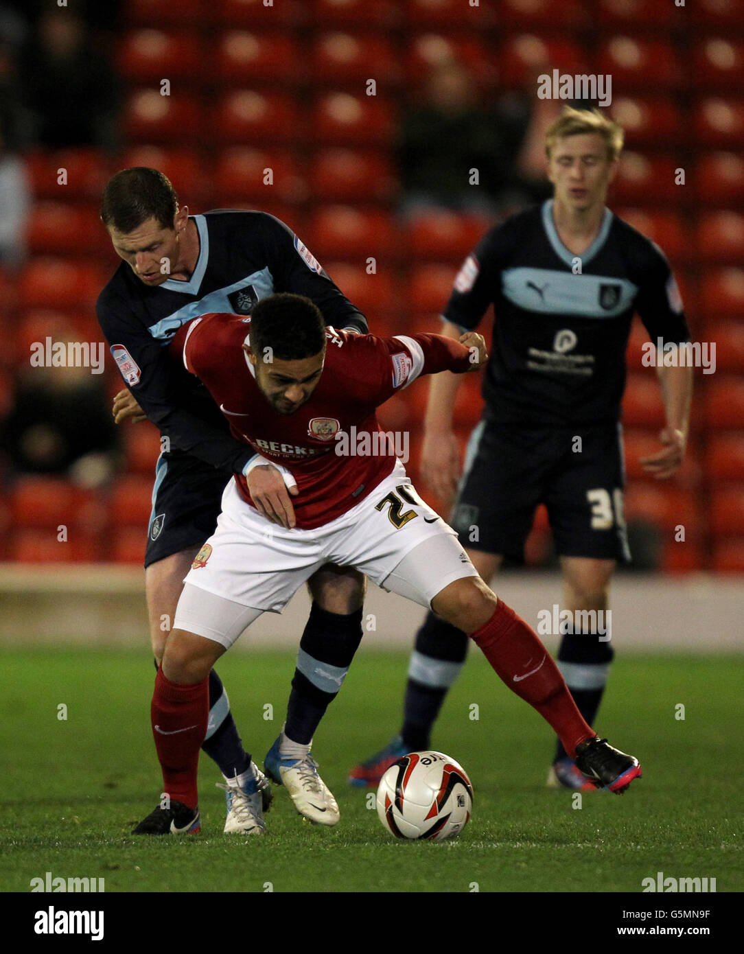 Barnsley's Reuben Noble-Lazarus holds off the challenge of Burnley's ...