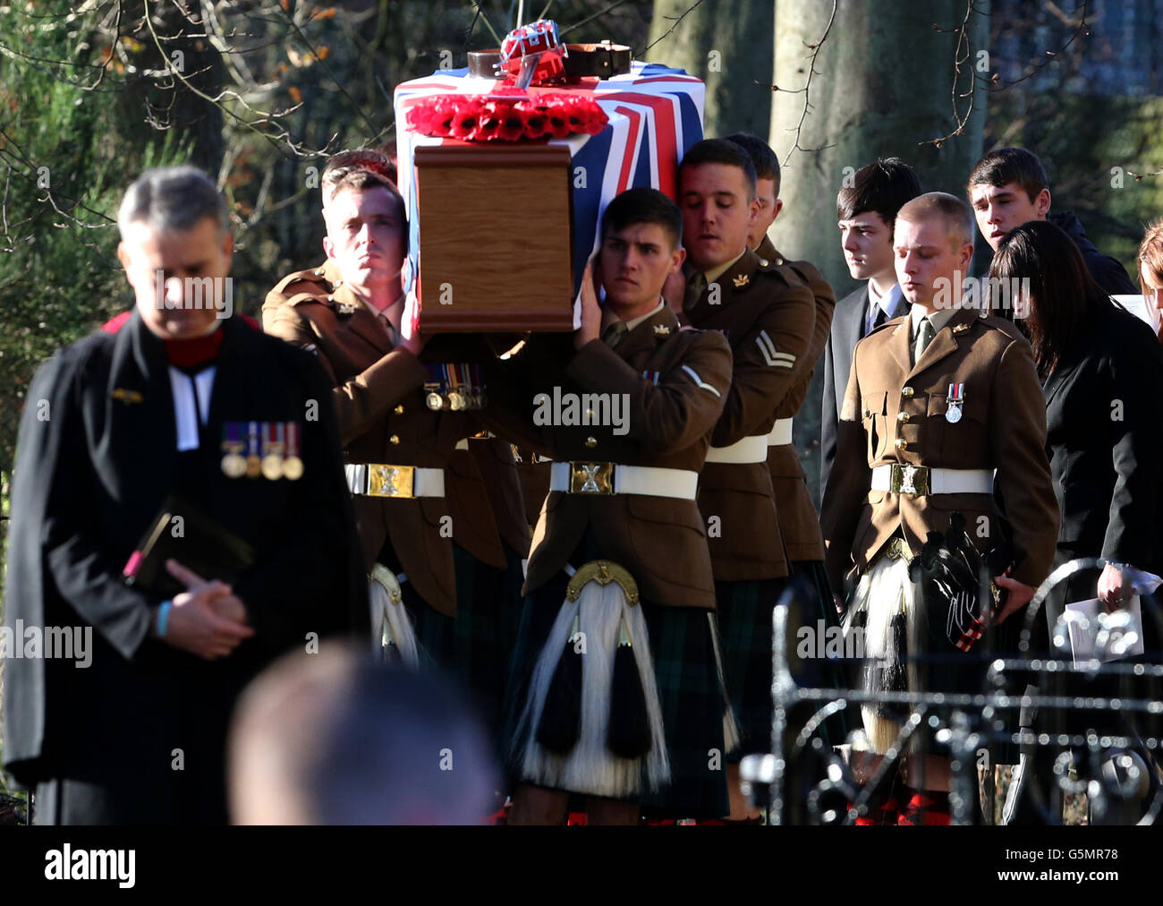 Sonia and son Callum follow the coffin of her husband Captain Walter ...