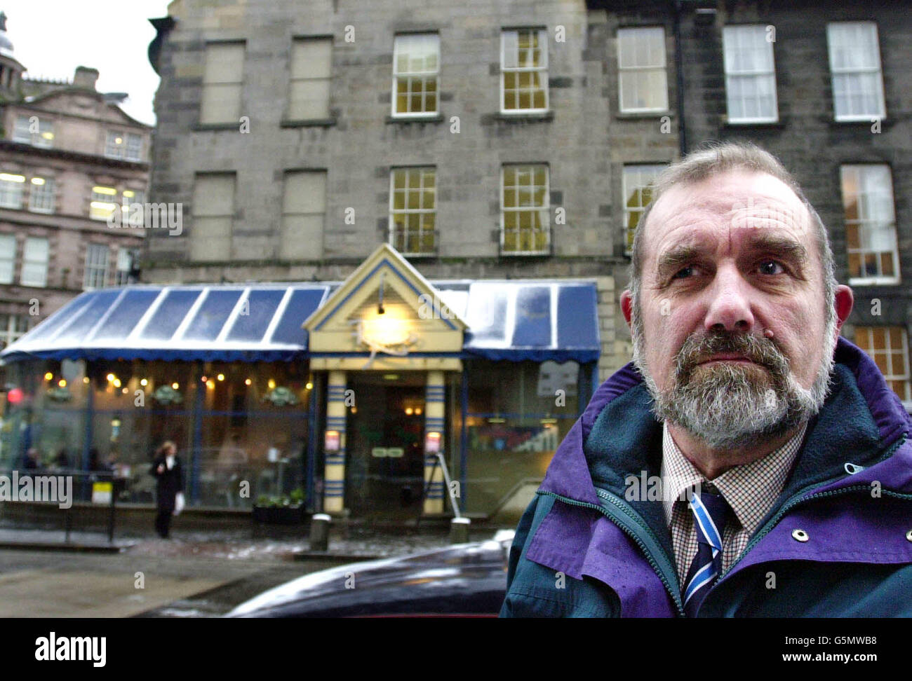 Michael Foster looks up at the spot from where heavy masonry crumbled ...